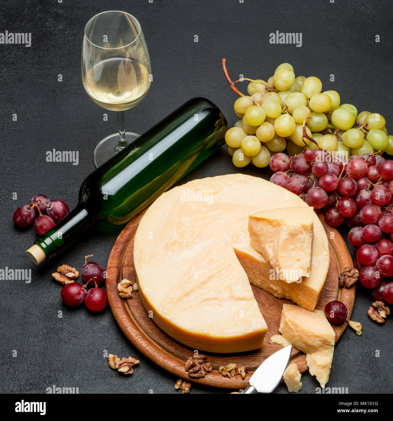 Whole round Head parmesan cheese, wine and grapes Stock Photo - Alamy