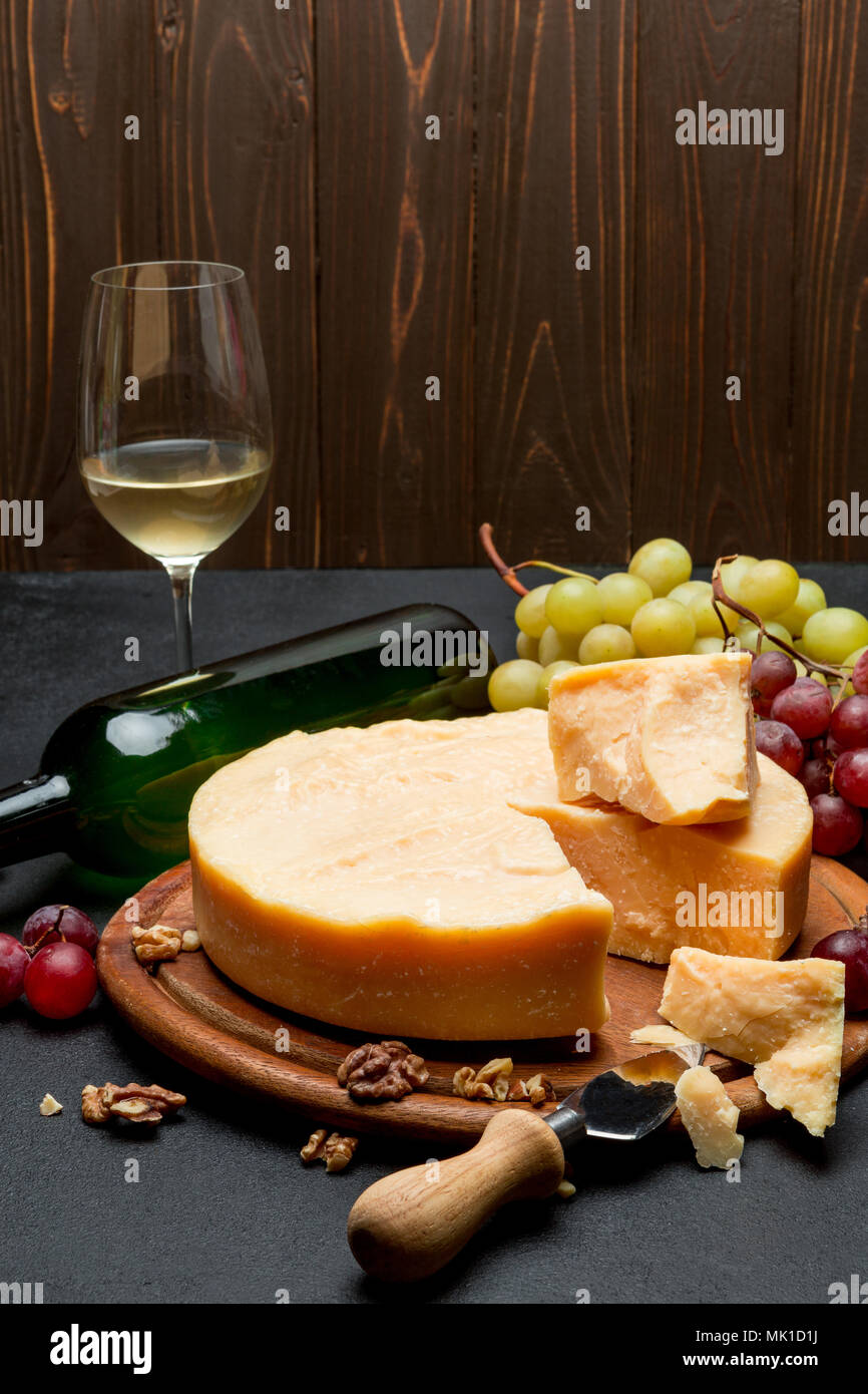Whole round Head parmesan cheese, wine and grapes Stock Photo - Alamy