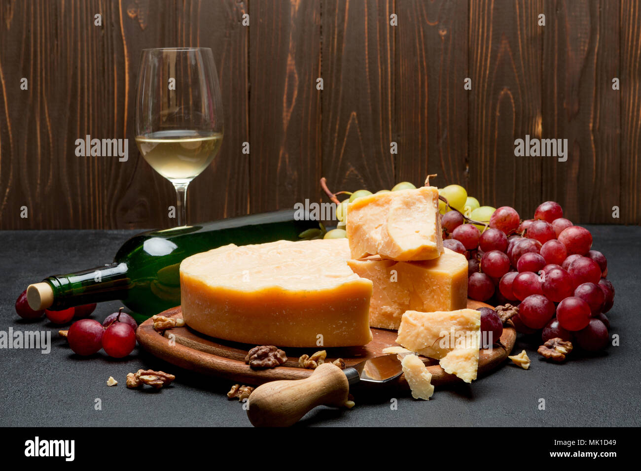 Whole round Head parmesan cheese, wine and grapes Stock Photo - Alamy