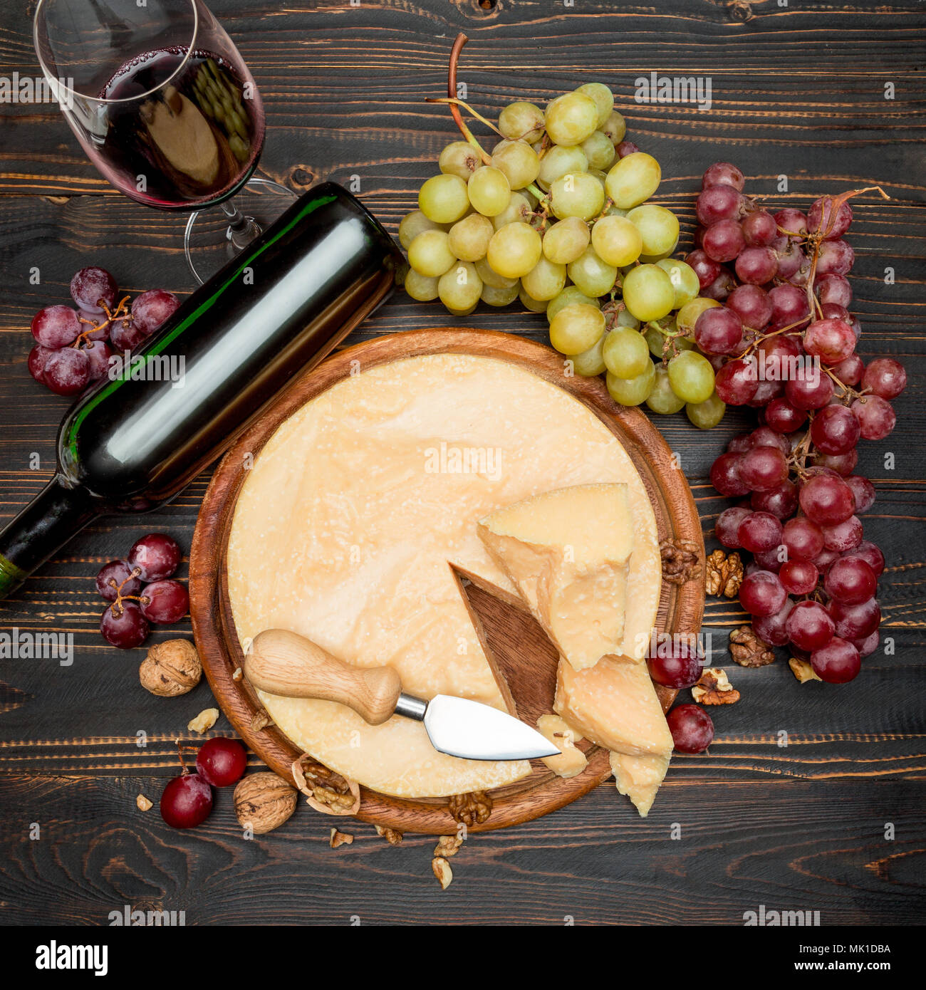 Whole round Head parmesan cheese, wine and grapes Stock Photo - Alamy