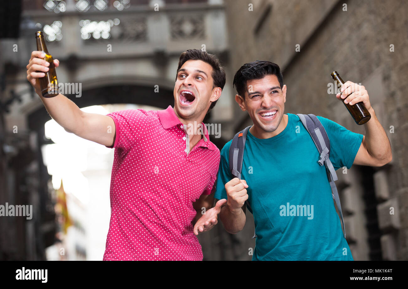 two active male fans who are walking with beer in Barcelona Stock Photo ...