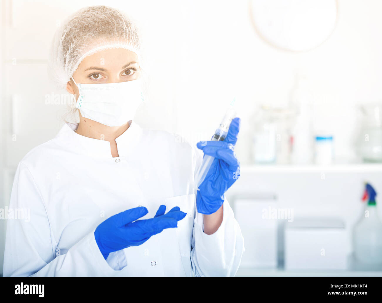 Female nurse holding syringe for injection in hospital Stock Photo - Alamy