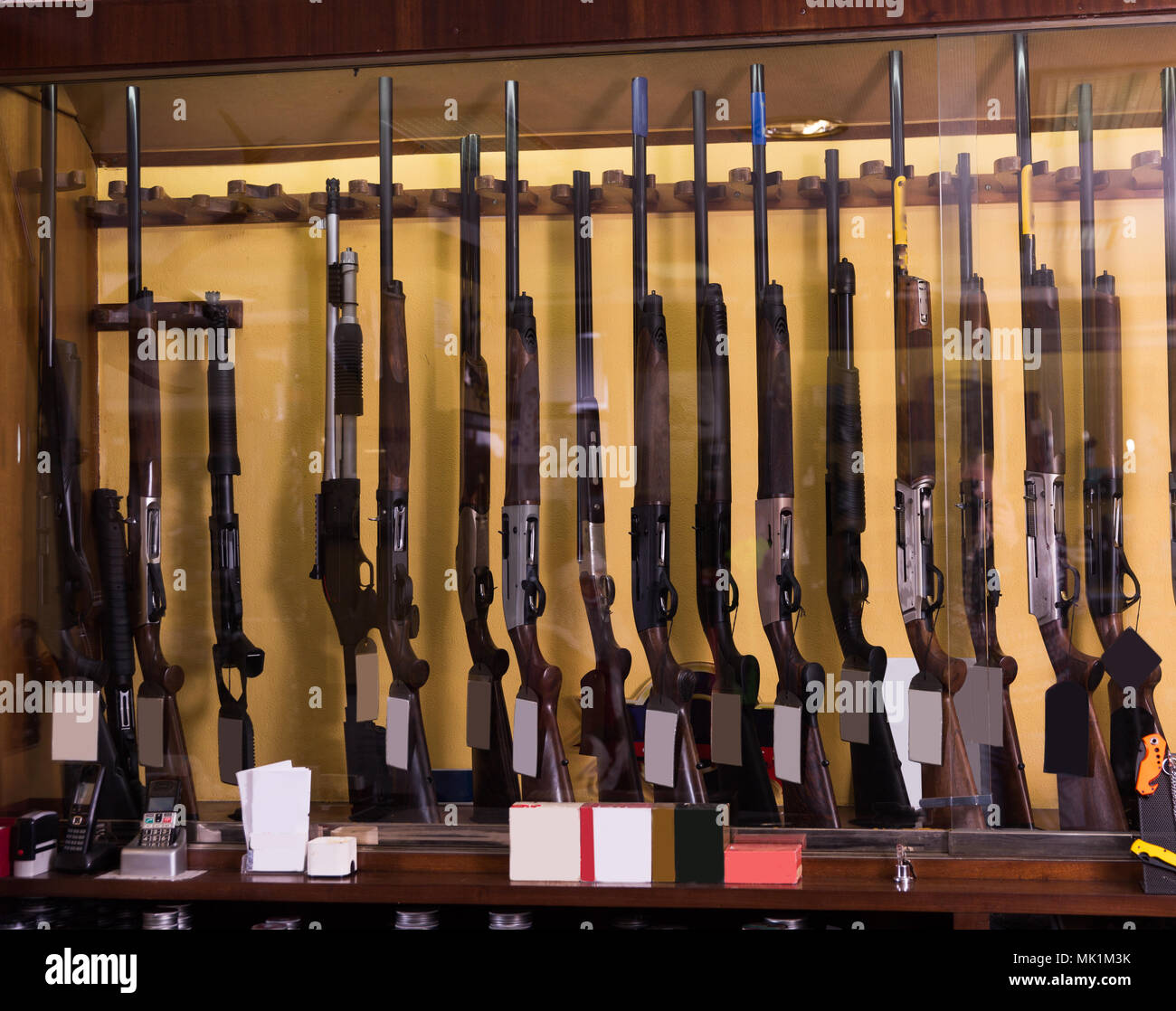 Gun store interior with different rifles on showcase Stock Photo - Alamy