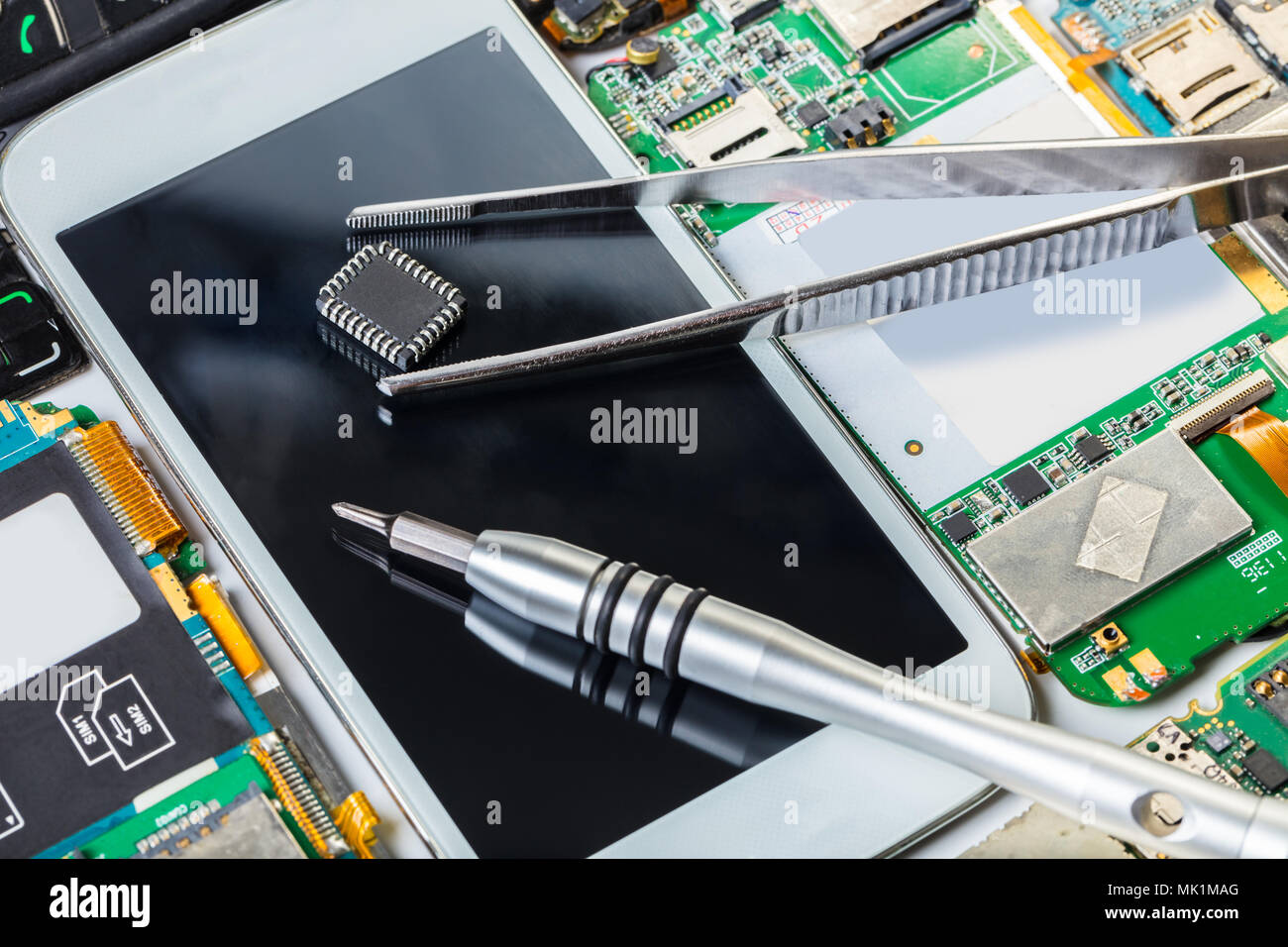 mobile phone with a tool on the background of electronic boards Stock ...