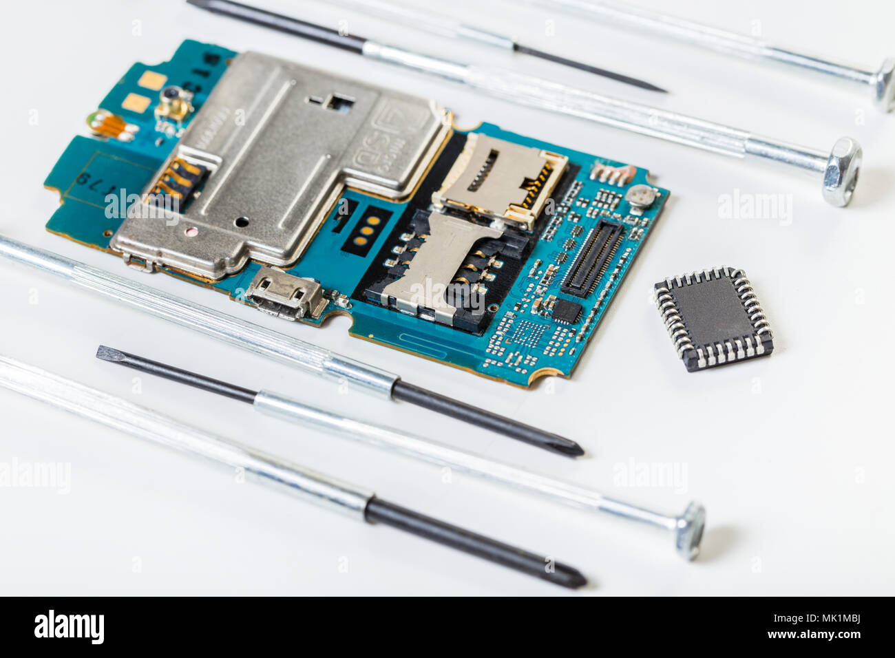 disassembled mobile phone and tools on white background Stock Photo - Alamy