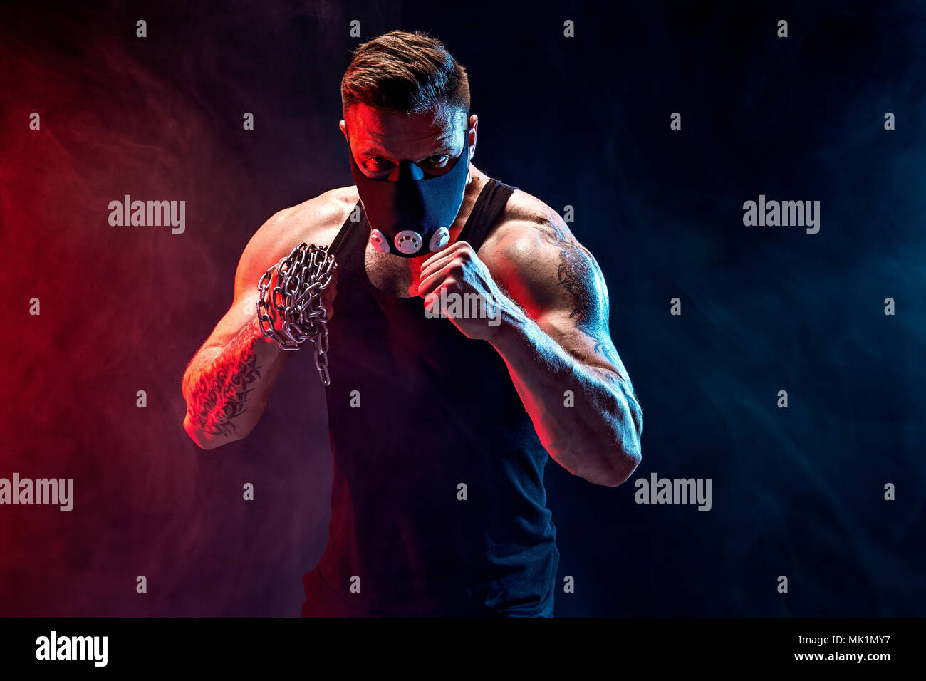 Serious muscular fighter in Training Mask doing the punch with the ...