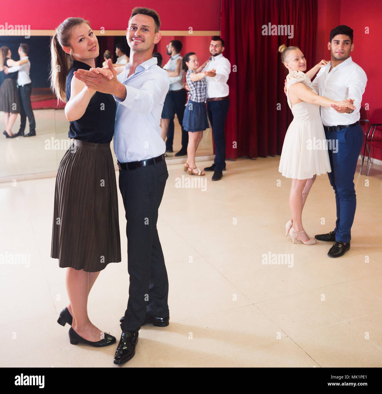 Young smiling people learning to dance waltz in dancing class Stock ...