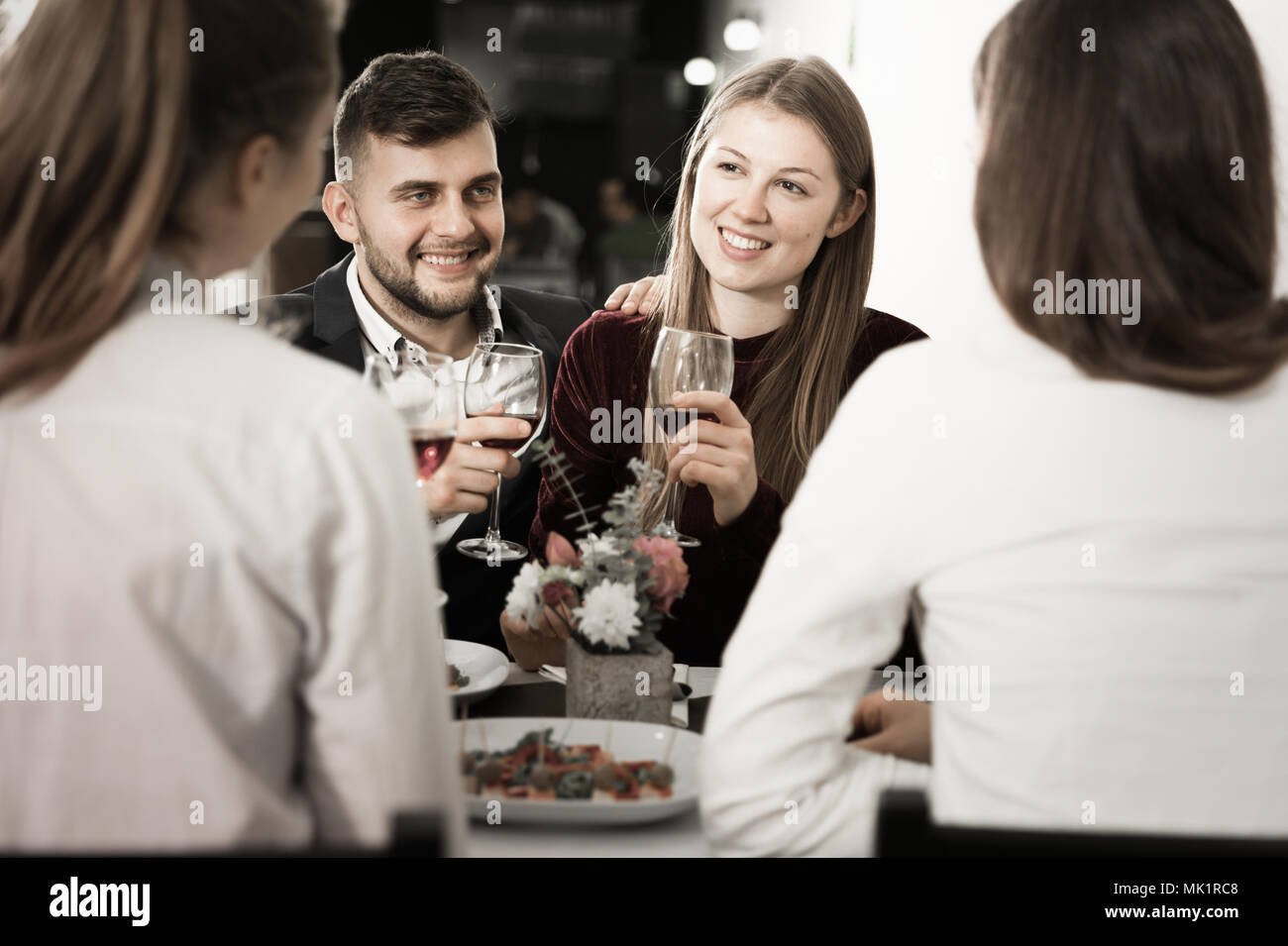 Friends are having dinner in the restaurante indoor Stock Photo - Alamy