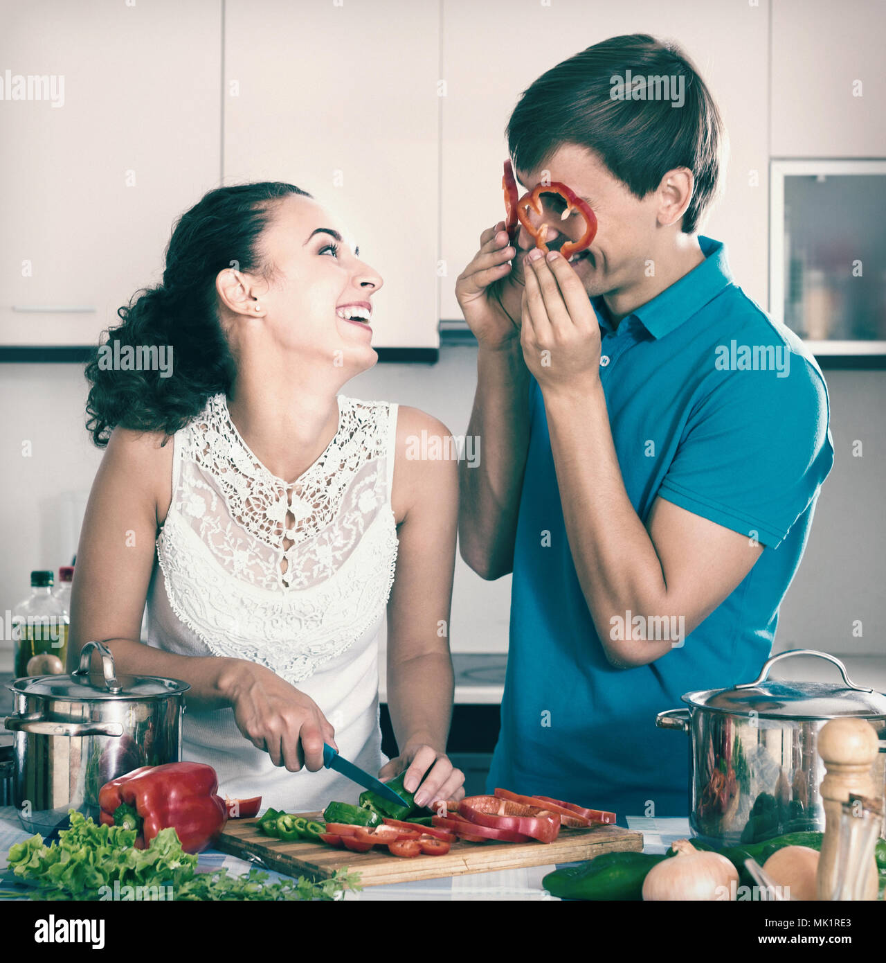 Happy family preparing veggies meal in domestic kitchen Stock Photo - Alamy