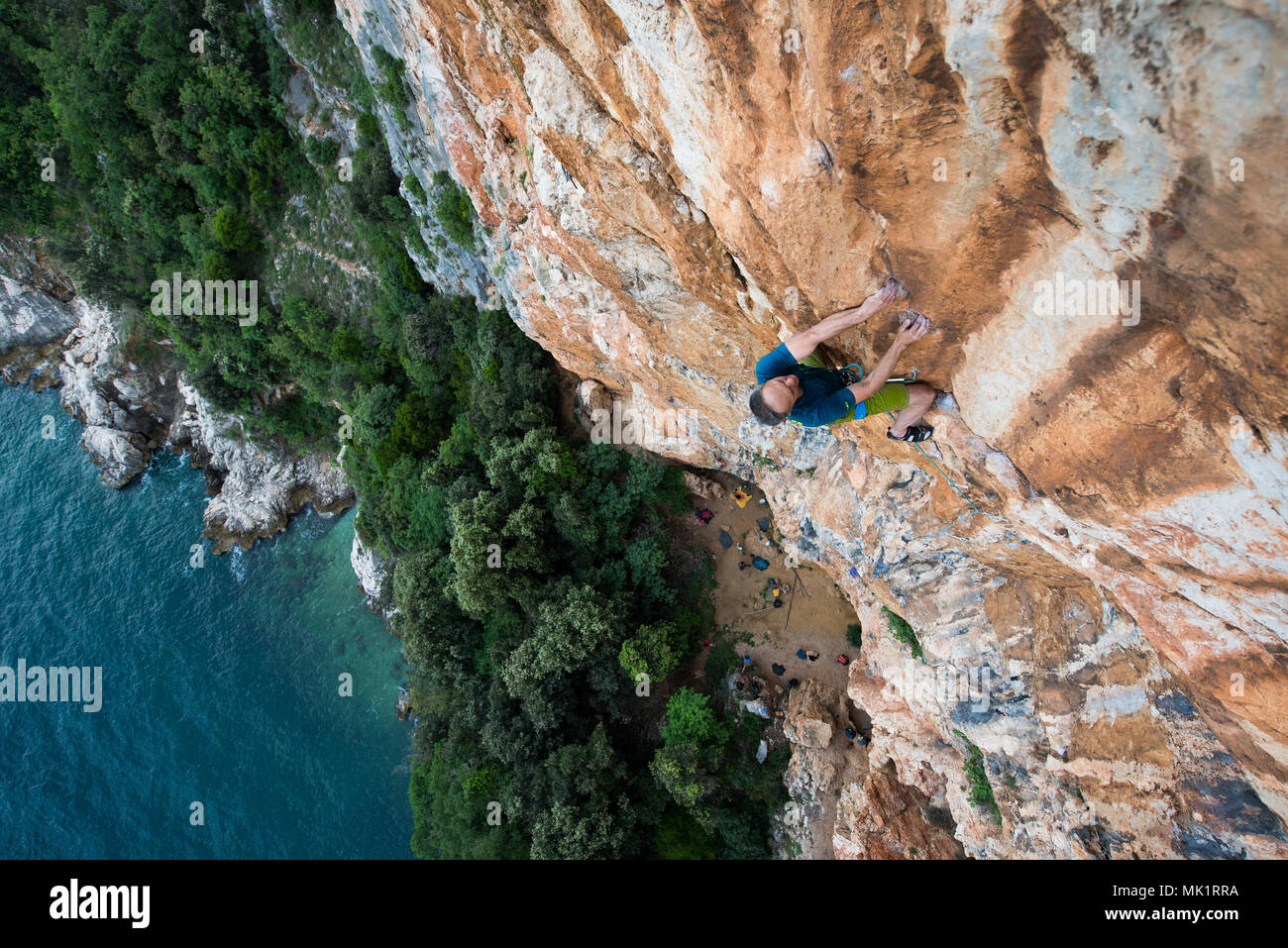 Rock climbing on exposed limestone cliff above sea Stock Photo - Alamy