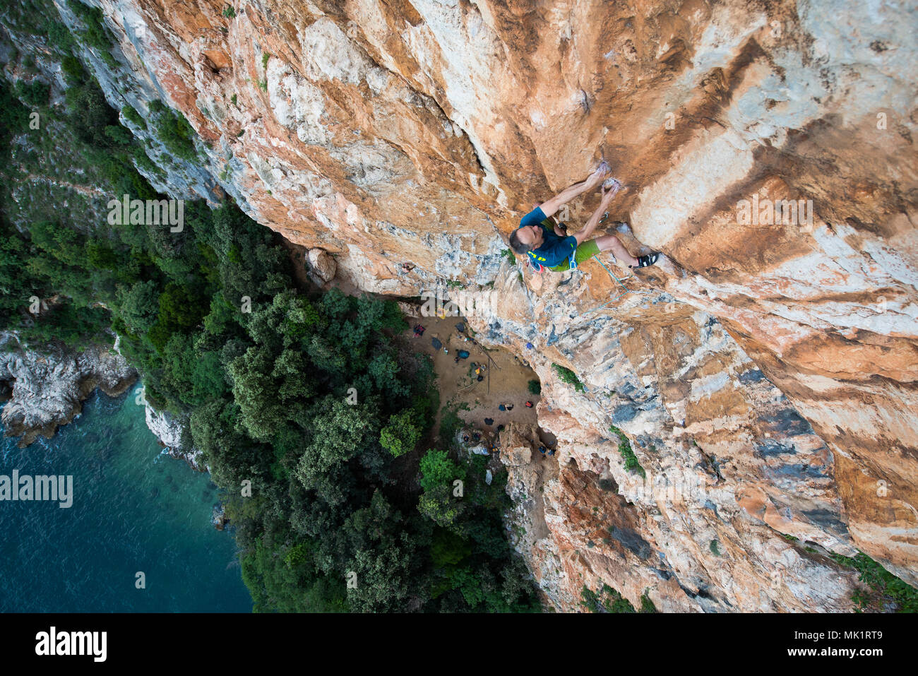 Rock climbing on exposed limestone cliff above sea Stock Photo - Alamy