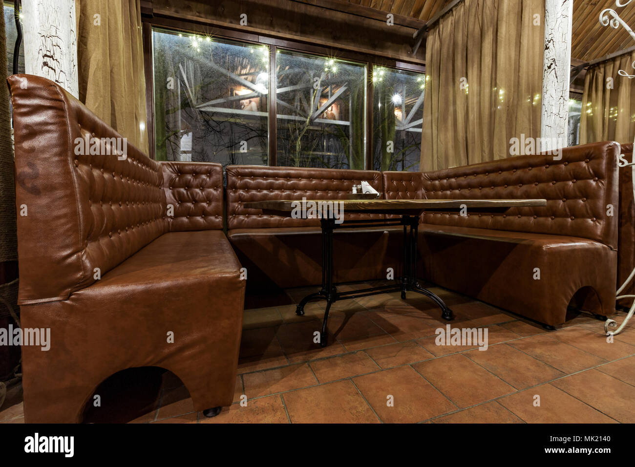 empty table with leather sofa in the restaurant, comfortable rest in ...