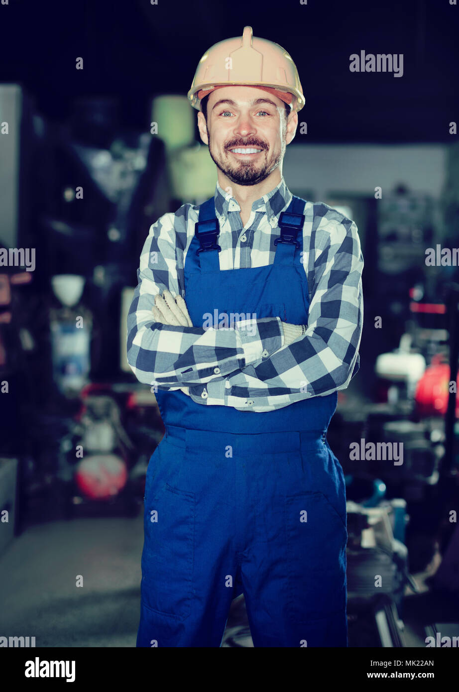 Young smiling guy displaying his workplace and tools at workshop Stock ...