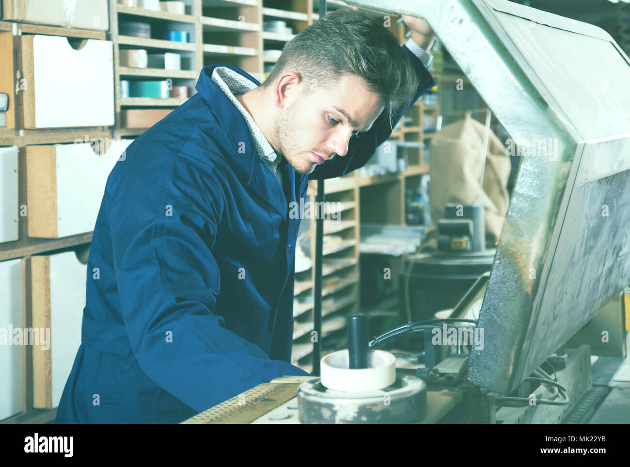 Young male joiner working with trimming machine at workplace Stock ...