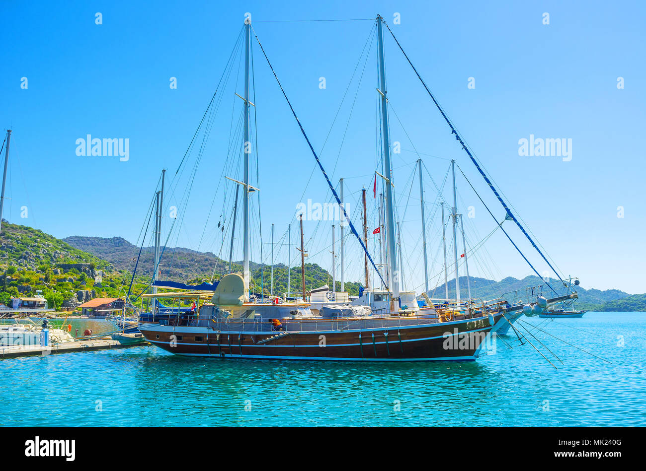 The sail yachts in shipyard of Ucagiz village amid the green mountains ...