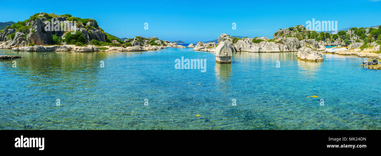The ancient Lycian sarcophagus in water, surrounded by rocks at the ...