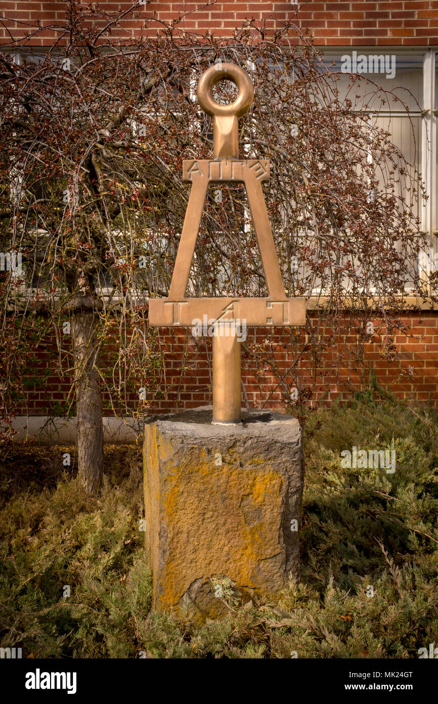 Triangle brass statue representing engineerin Stock Photo - Alamy