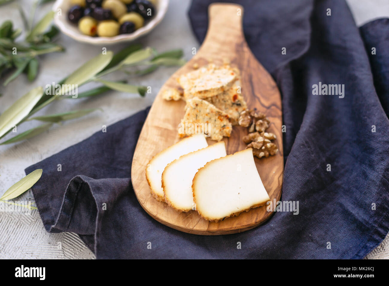 Small cheese board with two different sorts of cheese on black linen ...