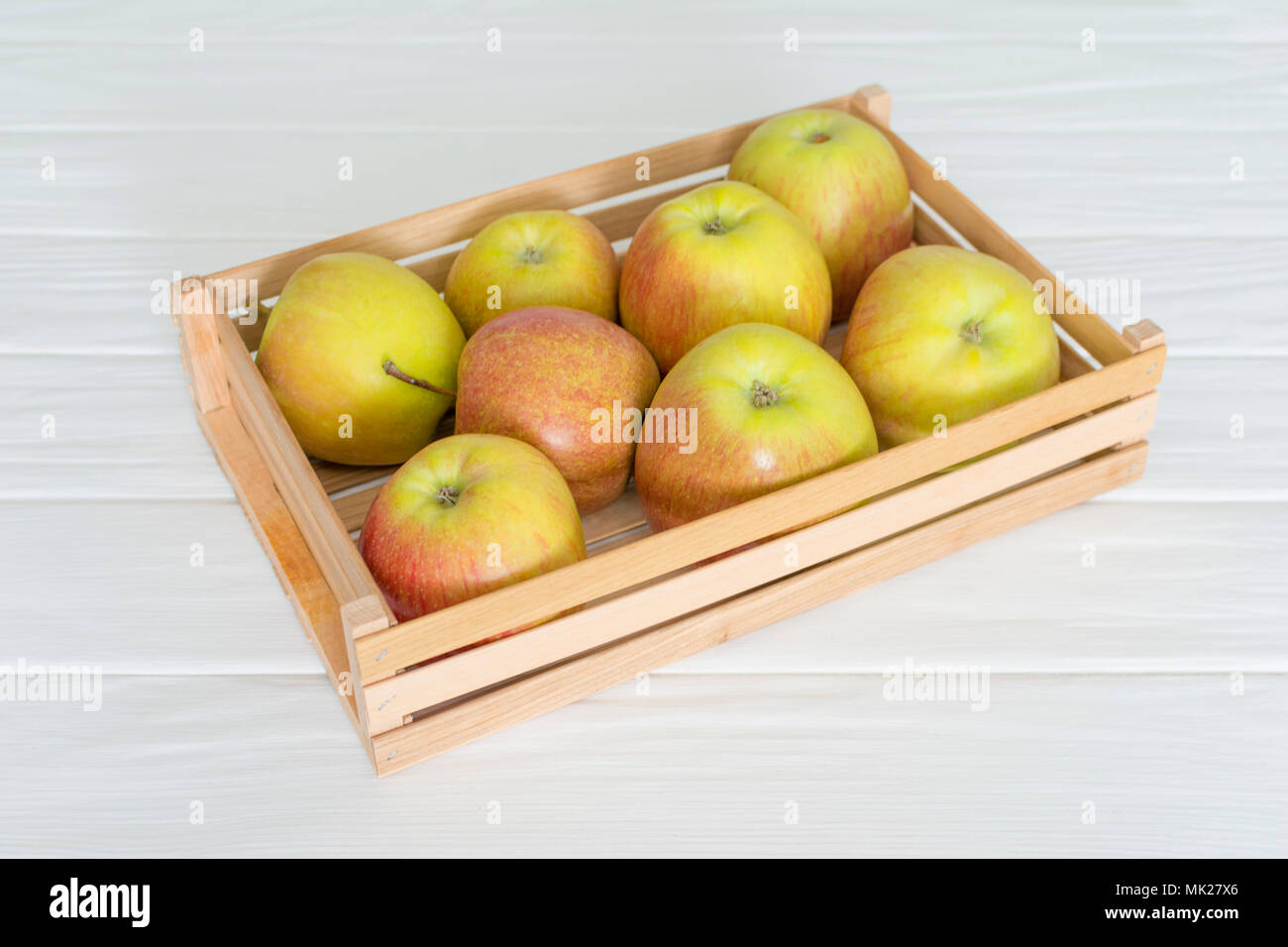 Wooden crate box full of fresh apples isolated on white table Stock ...