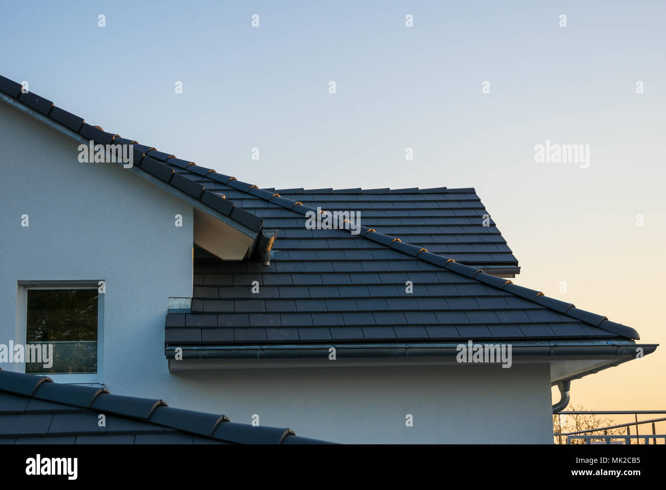 Germany, New Building house roof with rain pipe and window Stock Photo ...