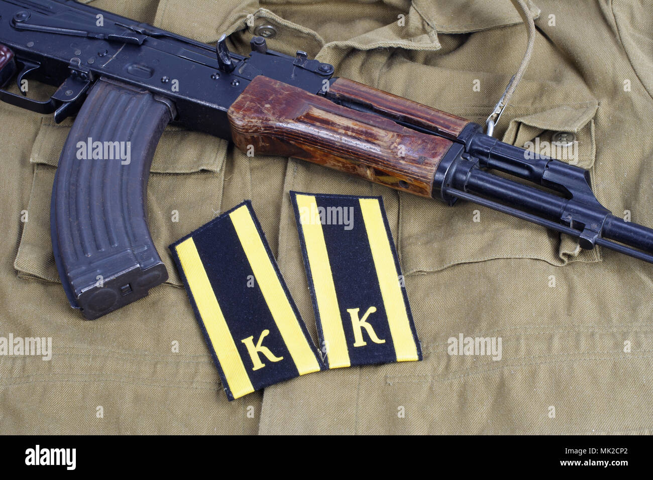 AK47 with Soviet Army Cadet shoulder mark on khaki uniform background ...
