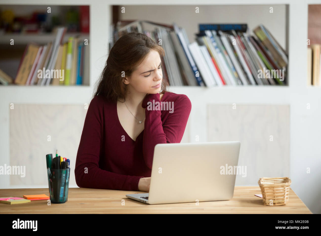 Tired female worker suffering from neck pain after hard work Stock ...