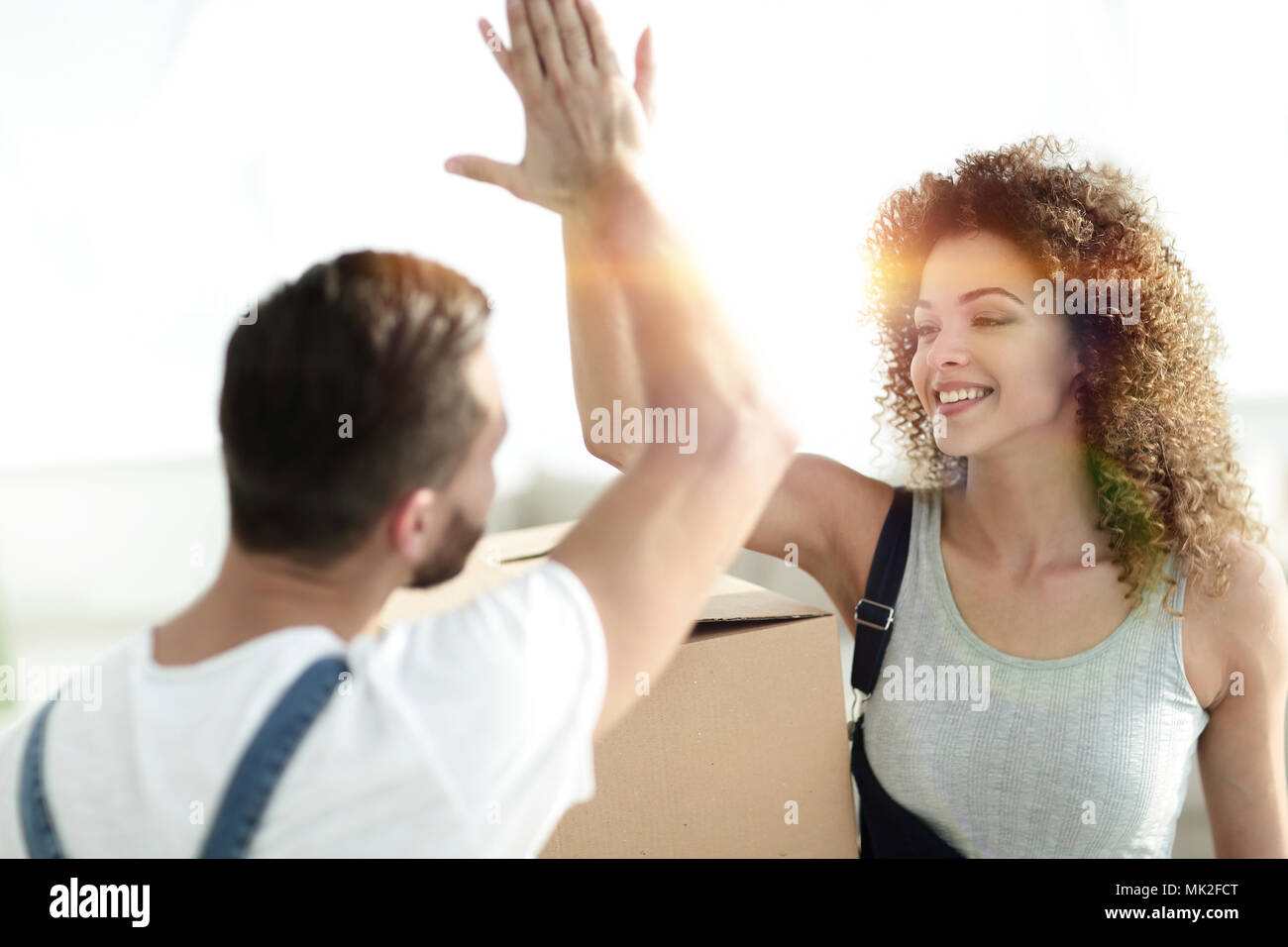 Happy and young couple giving a high five Stock Photo - Alamy