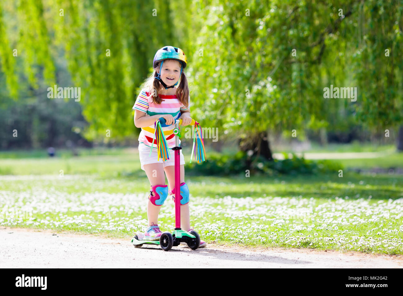 Child riding scooter. Kid on colorful kick board. Active outdoor fun ...