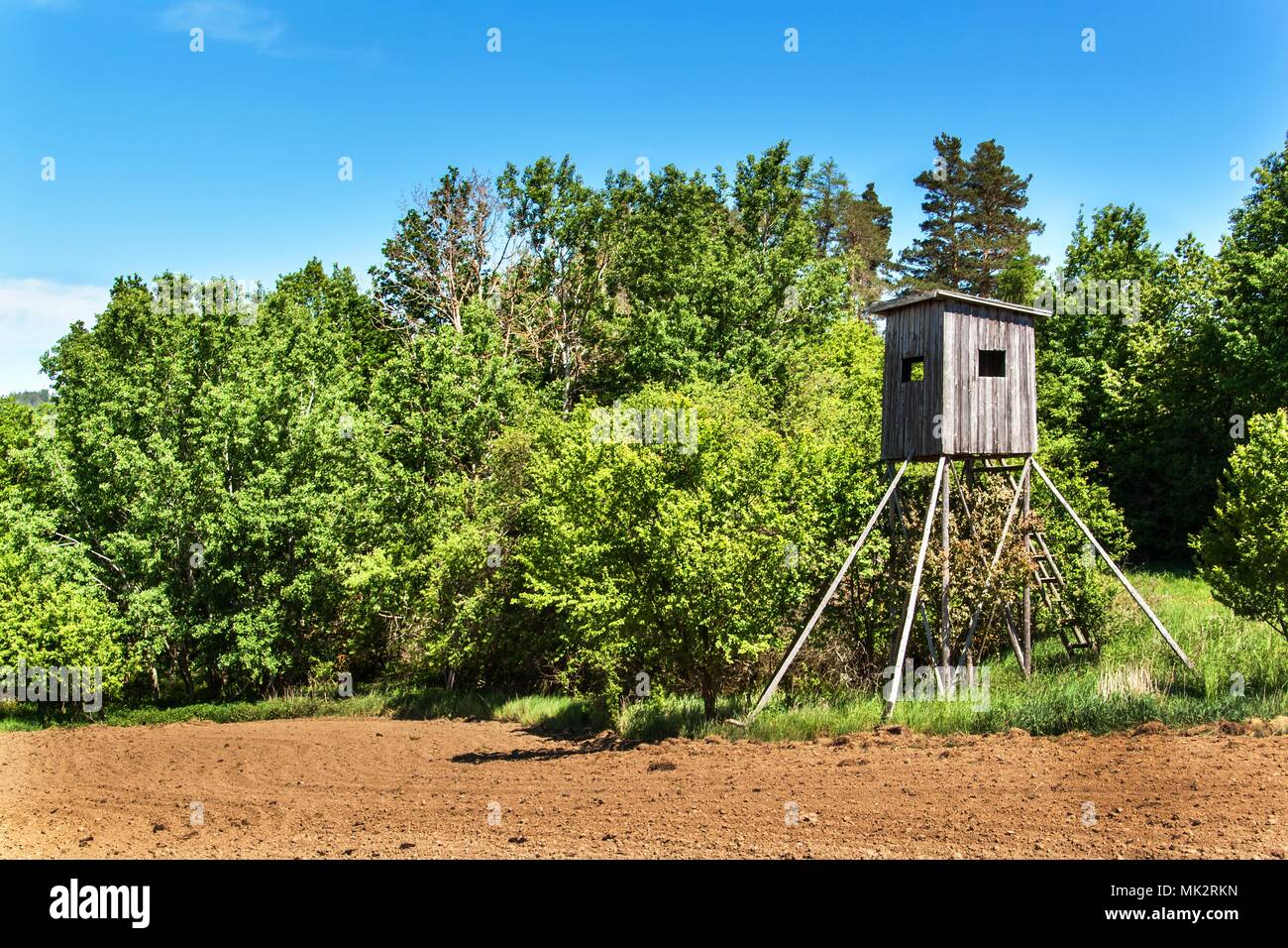 Wooden hunting watchtower in the Czech landscape. Countryside in the ...