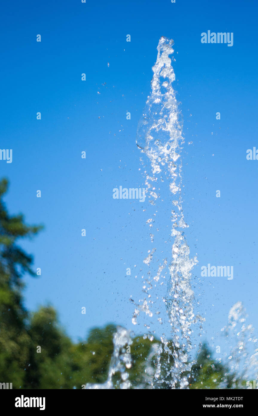 Fountain in city park on hot summer day, beautiful bright streams of ...