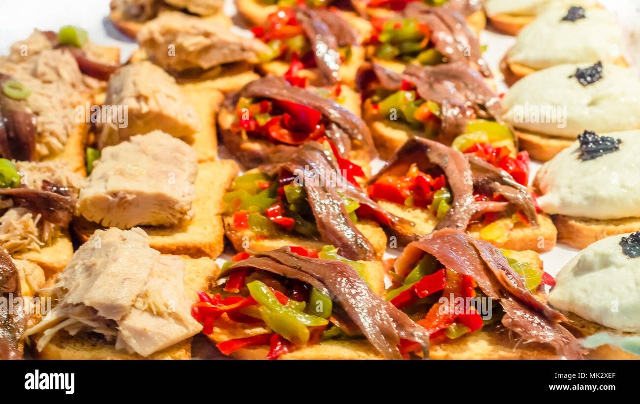 Typical Spanish tapas in a bar, consisting of a snack or appetizer that ...
