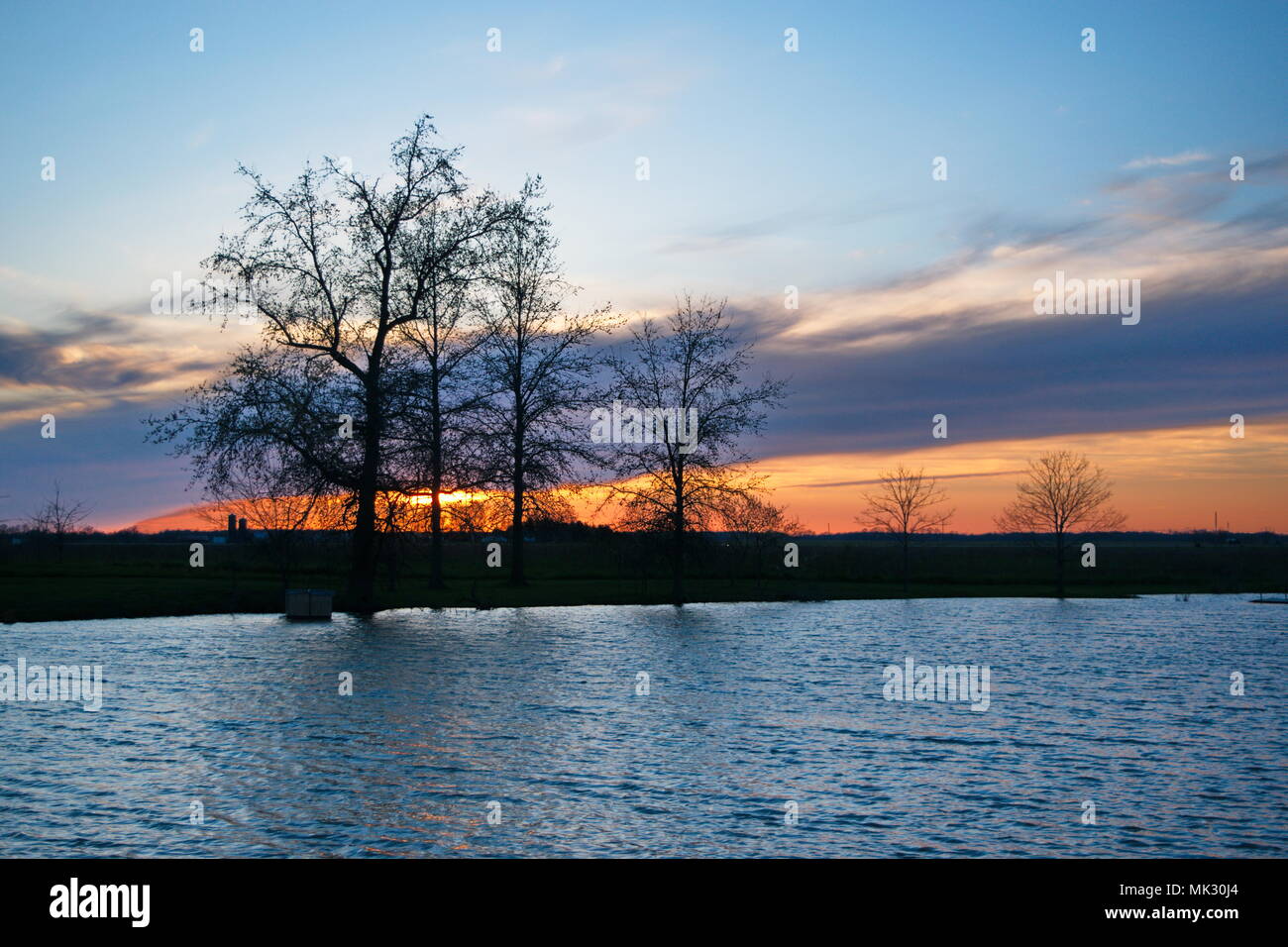 Evening sunset in rural country area in central Illinois over a pond ...