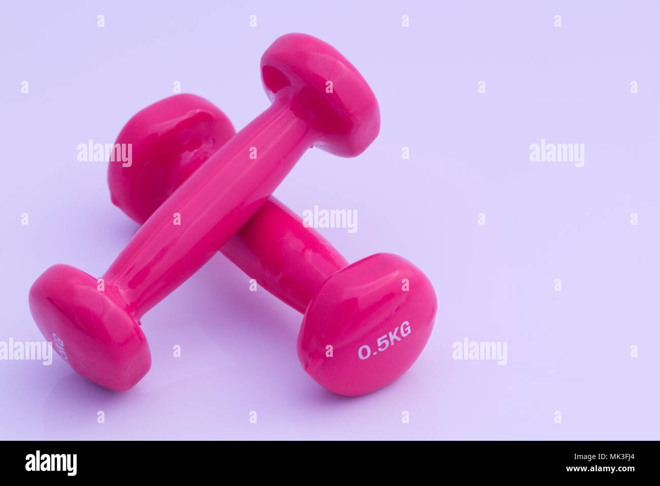 Colourful hand weights isolated on a white background with copy space ...