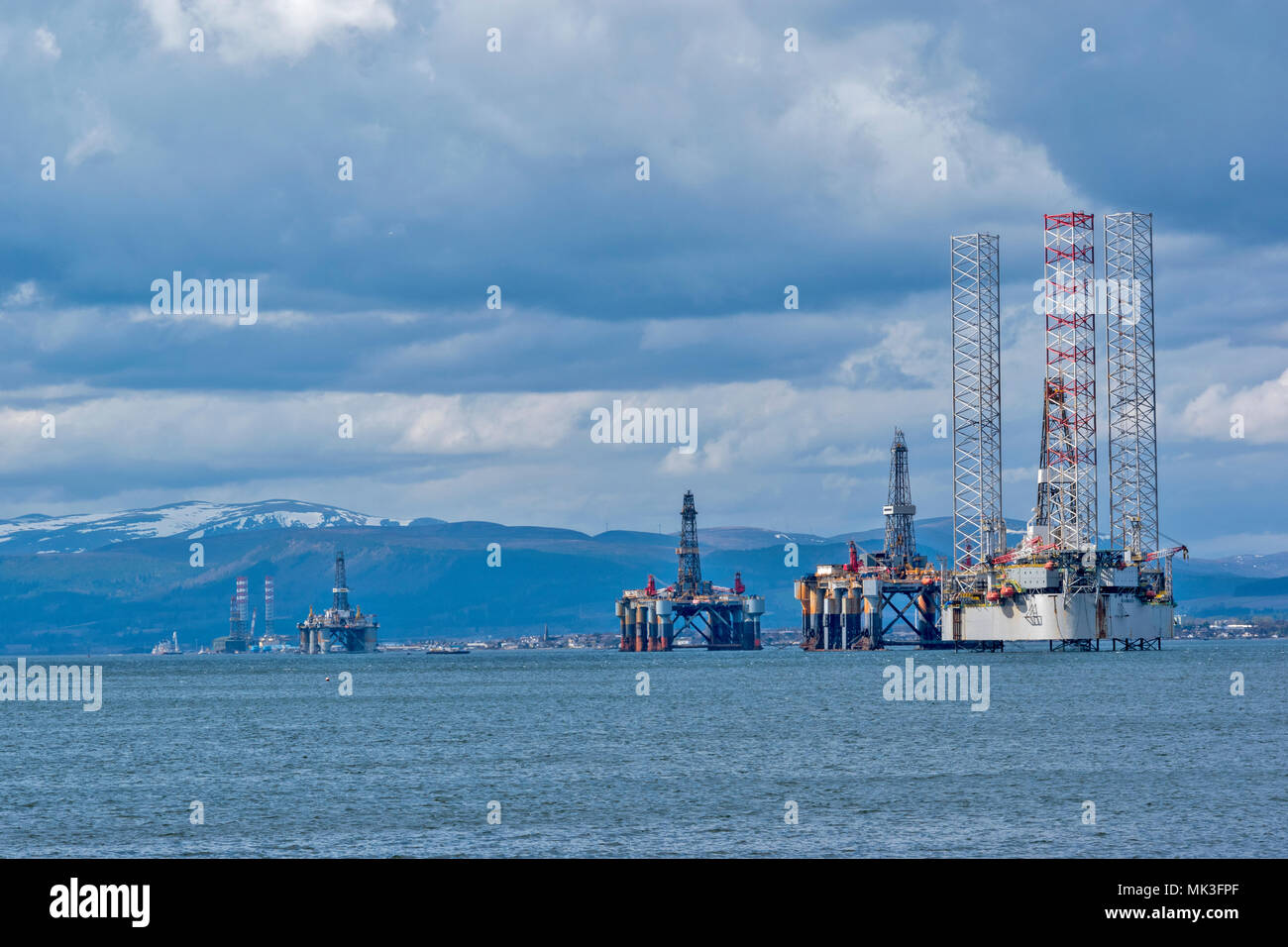 CROMARTY FIRTH SCOTLAND A LINE OF OIL PLATFORMS AND DECOMMISSIONED OIL ...