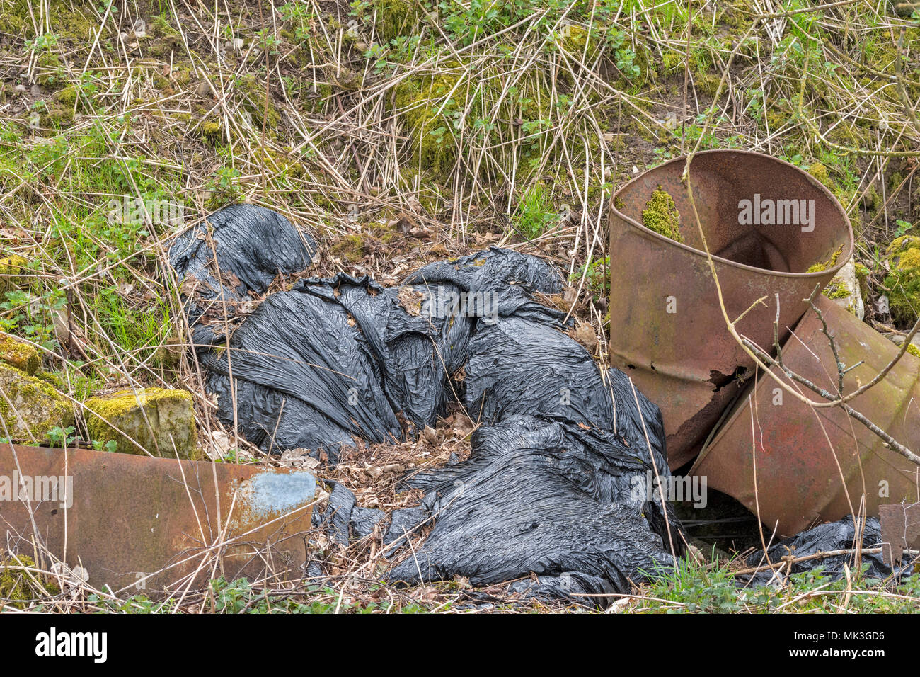DISCARDED OLD PLASTIC WRAPPERS FROM FARM BALES OF HAY OR SILEAGE LYING ...