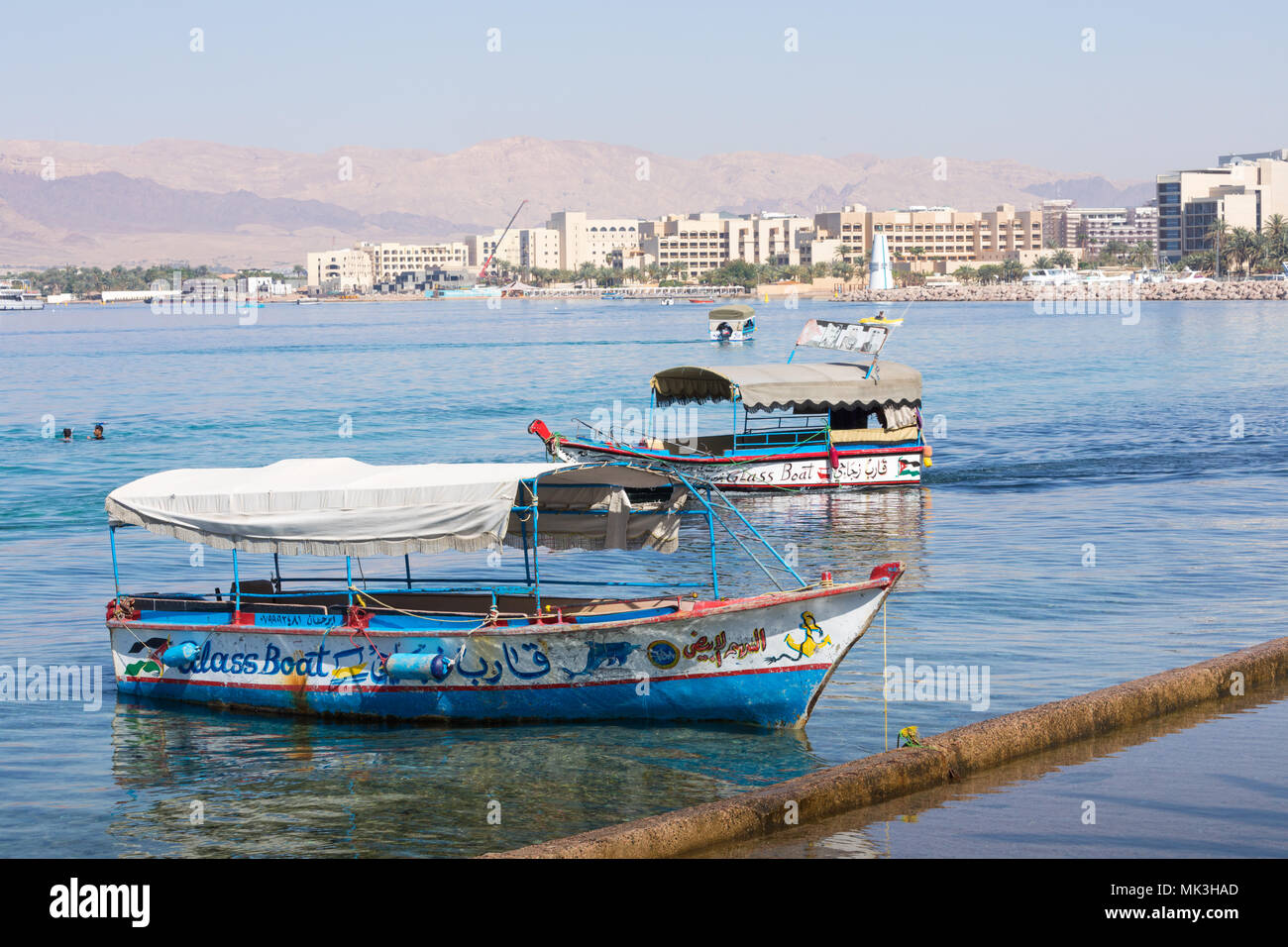 Touristic ships on the beach of Aqaba, Jordan. Popular resort, located ...