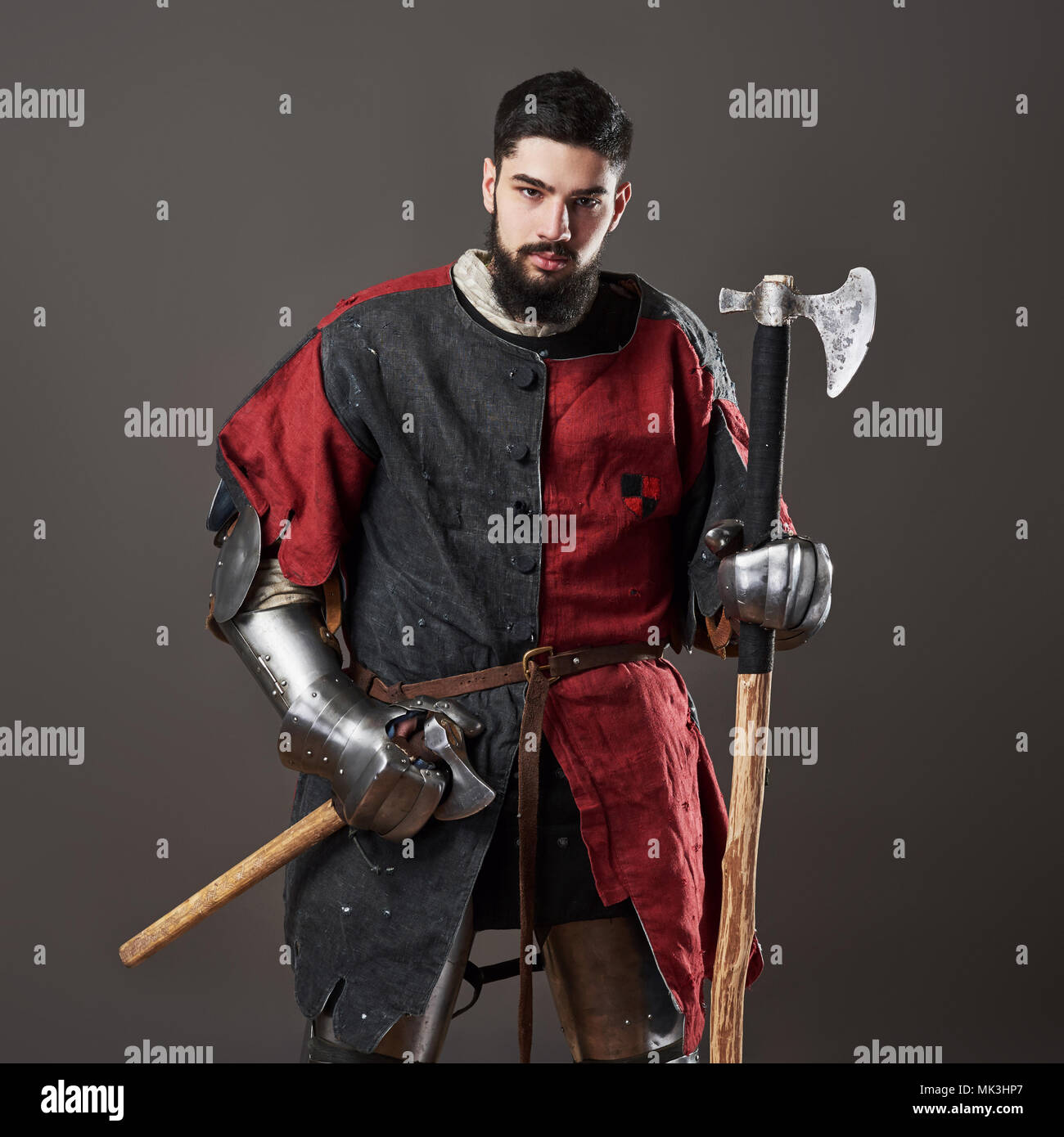 Medieval knight on grey background. Portrait of brutal dirty face ...