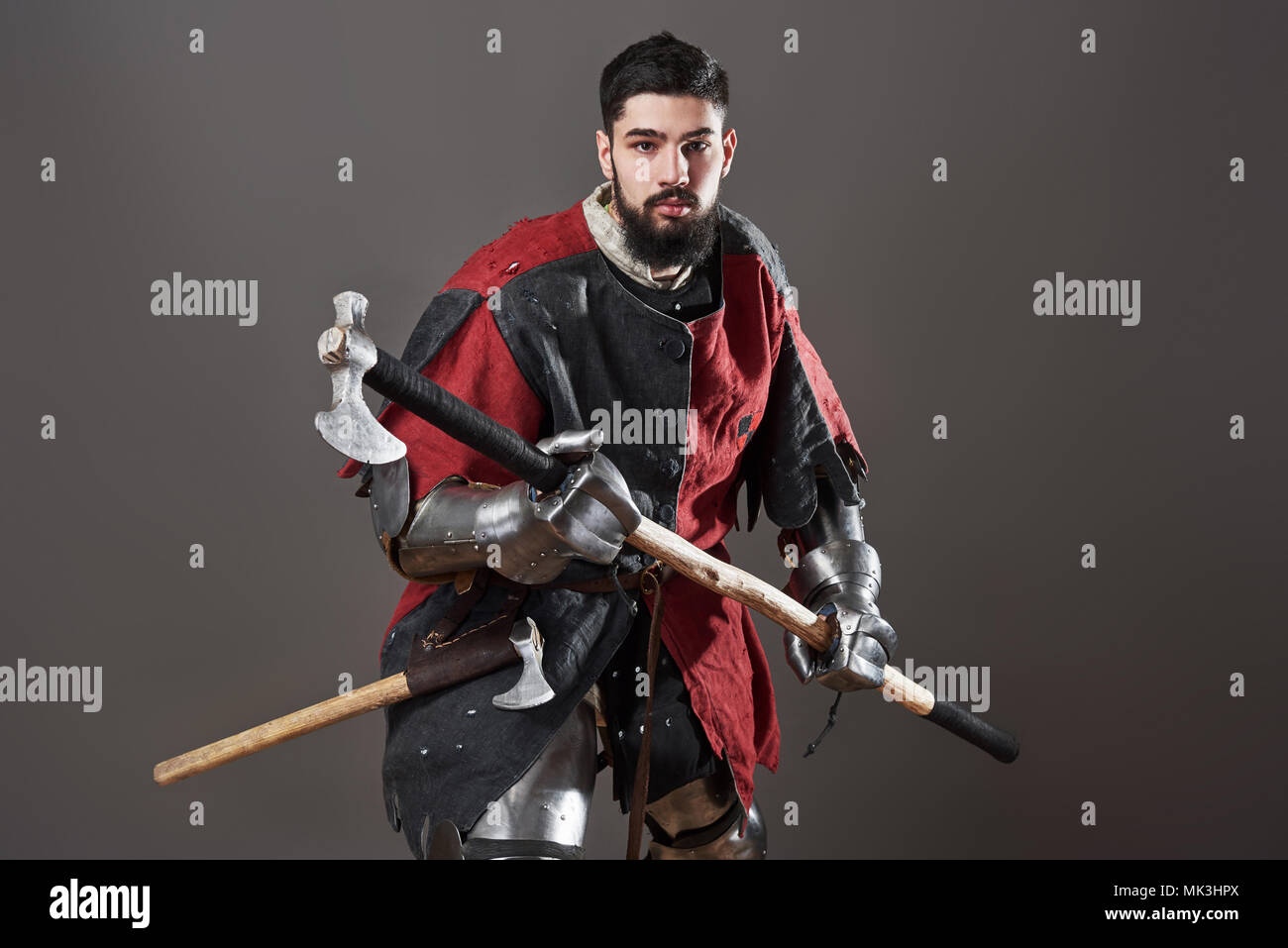 Medieval knight on grey background. Portrait of brutal dirty face ...
