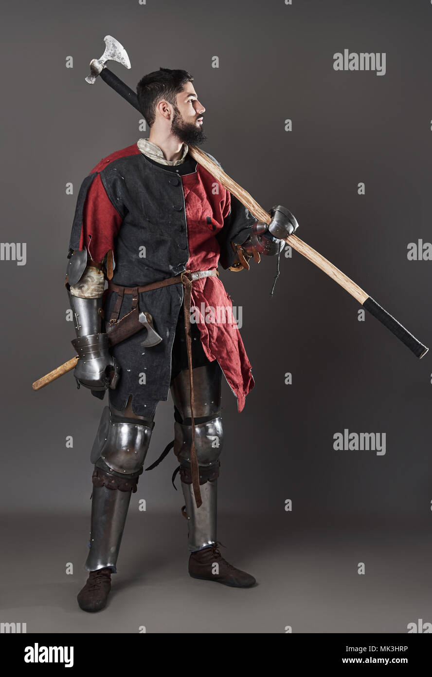 Medieval knight on grey background. Portrait of brutal dirty face ...