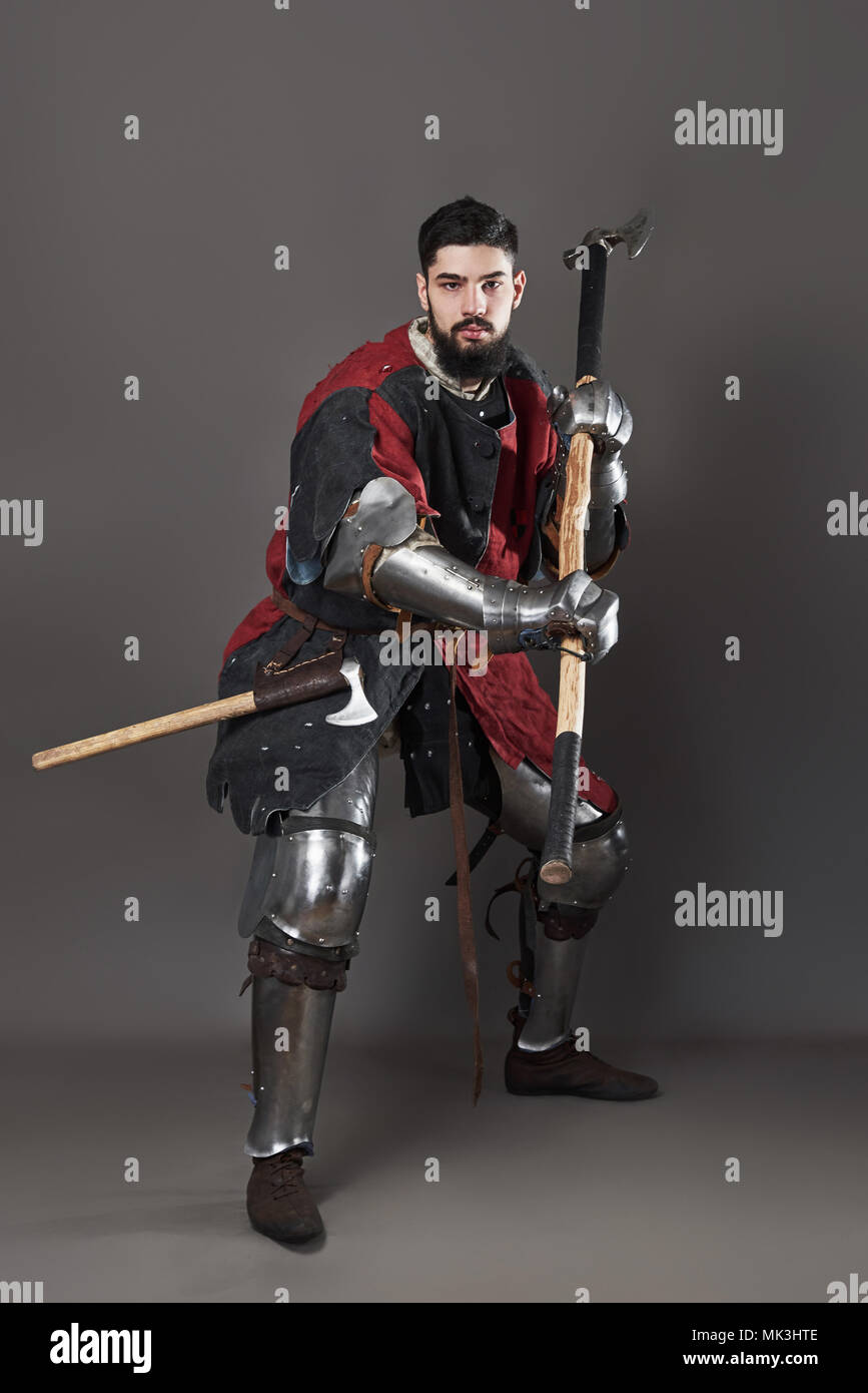 Medieval knight on grey background. Portrait of brutal dirty face ...