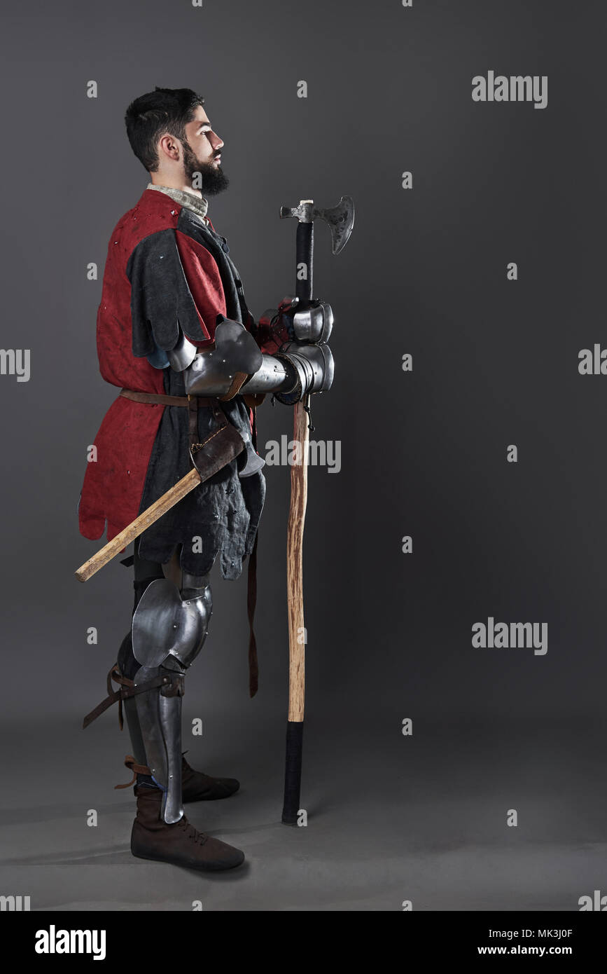 Medieval knight on grey background. Portrait of brutal dirty face ...