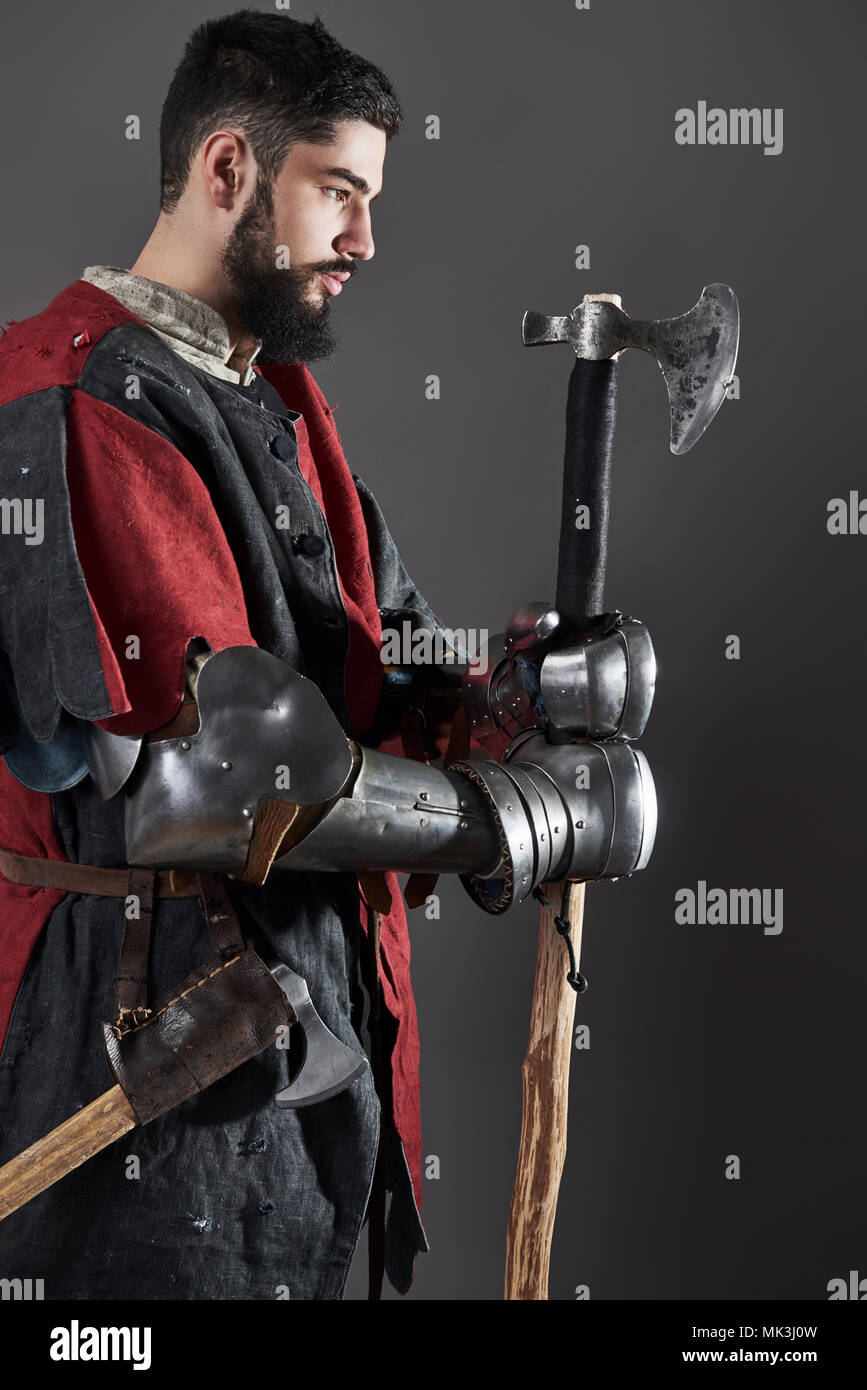 Medieval knight on grey background. Portrait of brutal dirty face ...