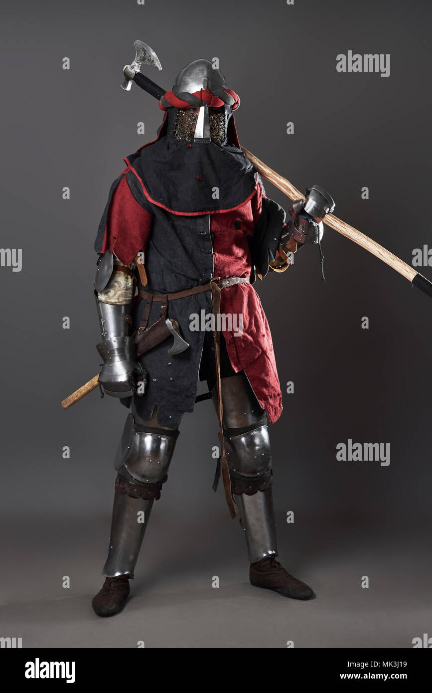 Medieval knight on grey background. Portrait of brutal dirty face ...