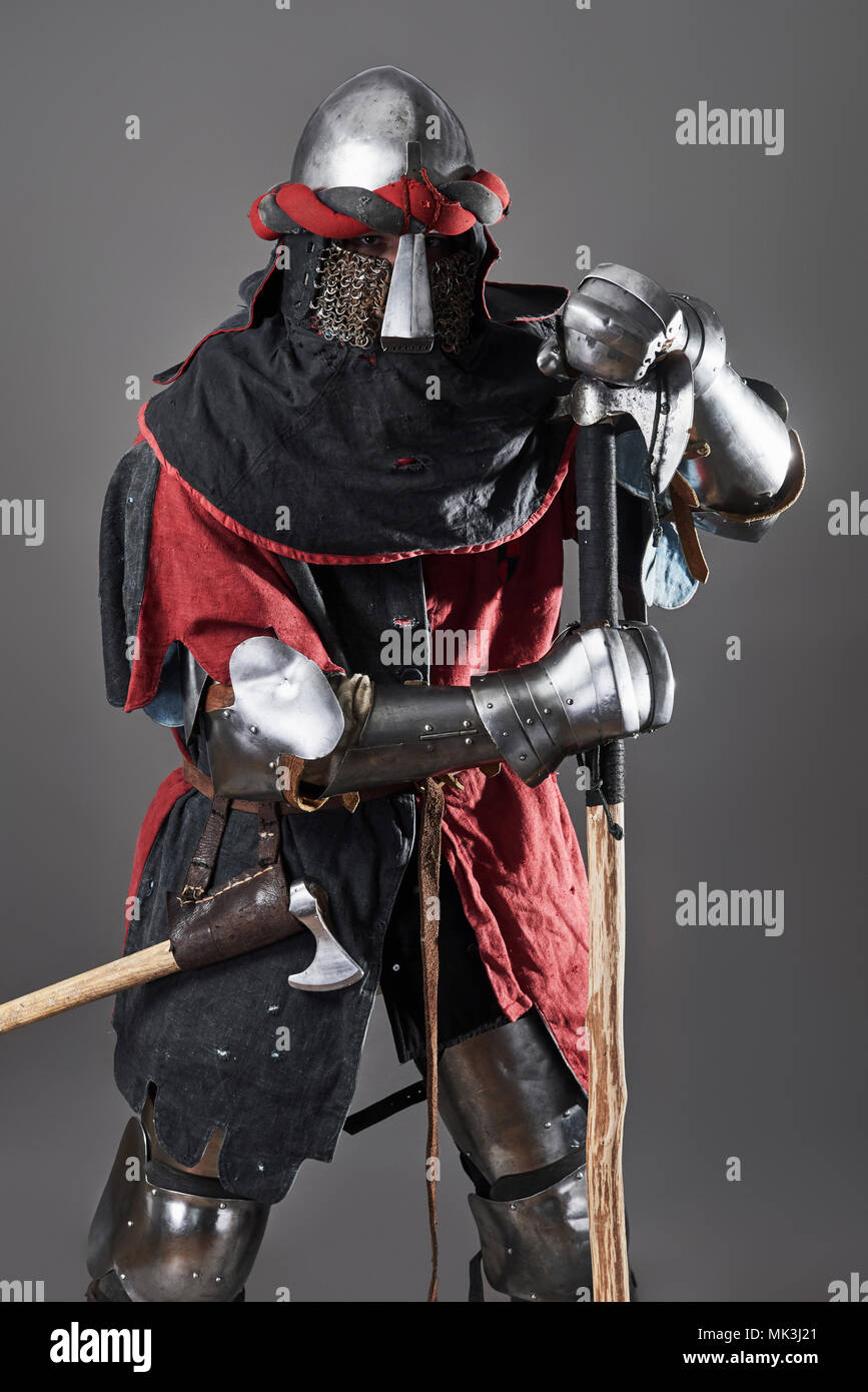 Medieval knight on grey background. Portrait of brutal dirty face ...