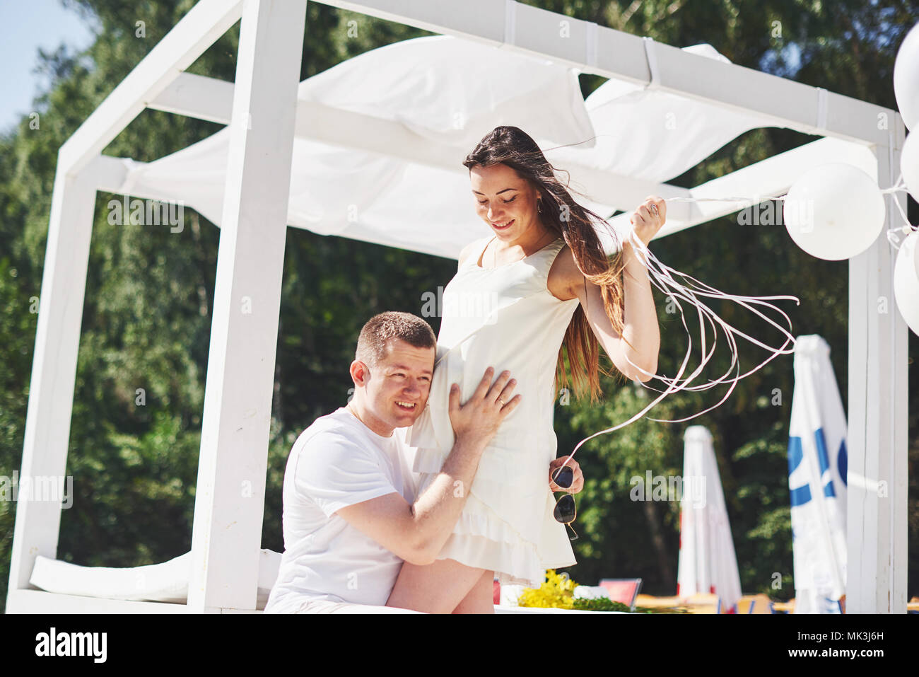 Happy And Young Pregnant Couple Hugging In Nature Romantic Moments