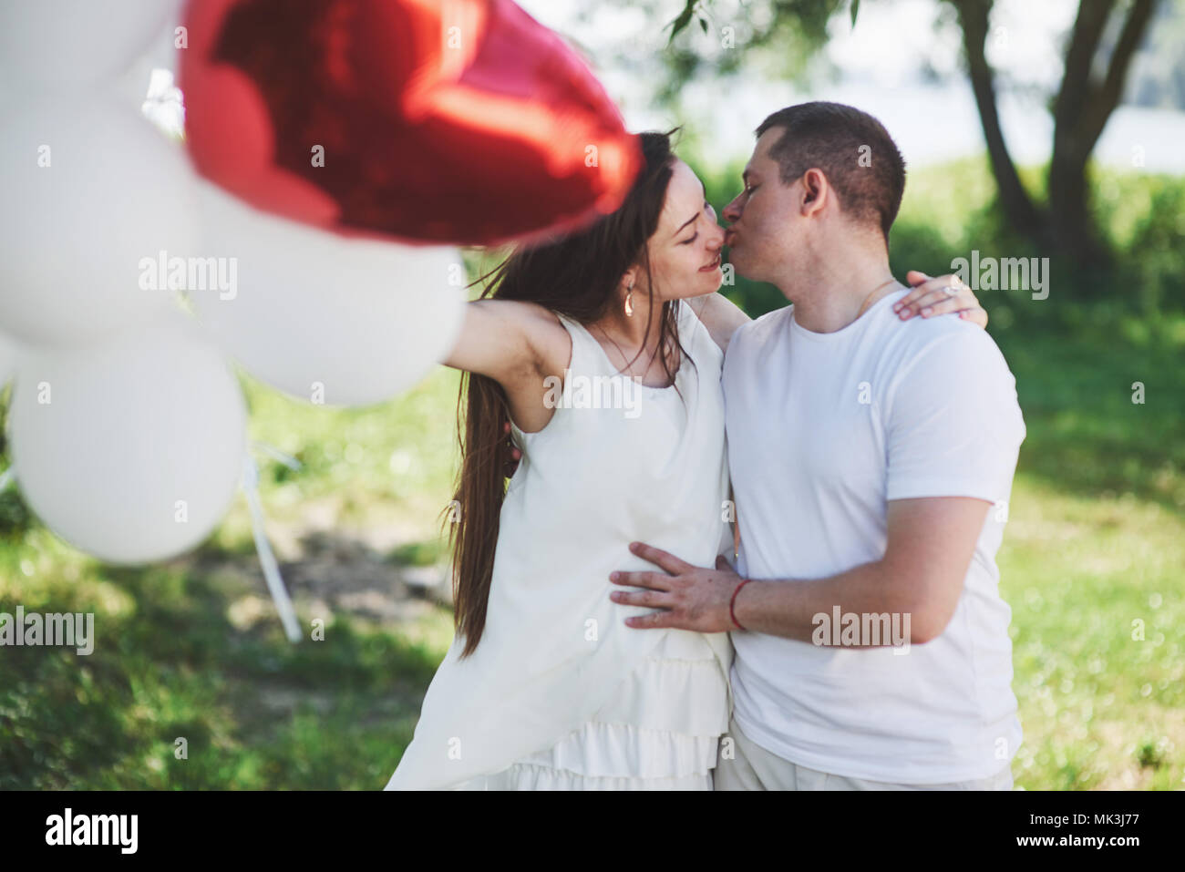 Happy And Young Pregnant Couple Hugging In Nature Romantic Moments