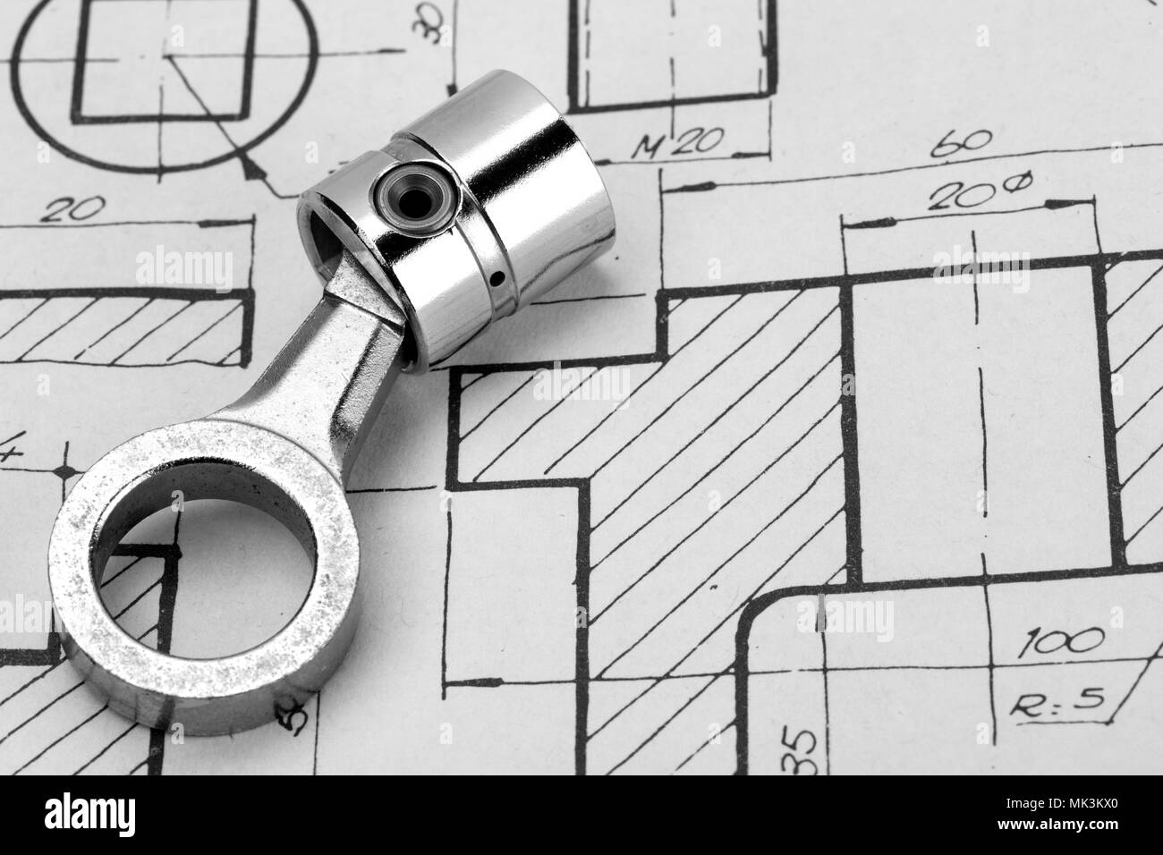 piston on engineering design paper with technical draws, black and ...
