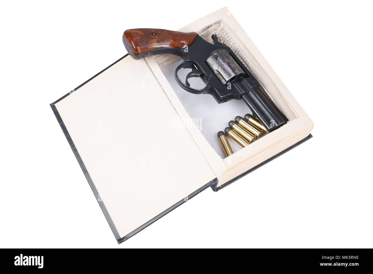Revolver gun with cartridges hidden in a book isolated on white ...