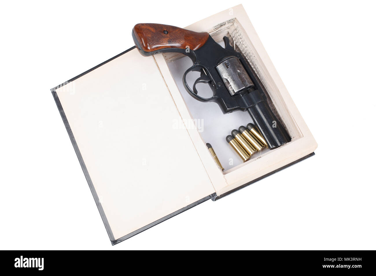 Revolver gun with cartridges hidden in a book isolated on white ...
