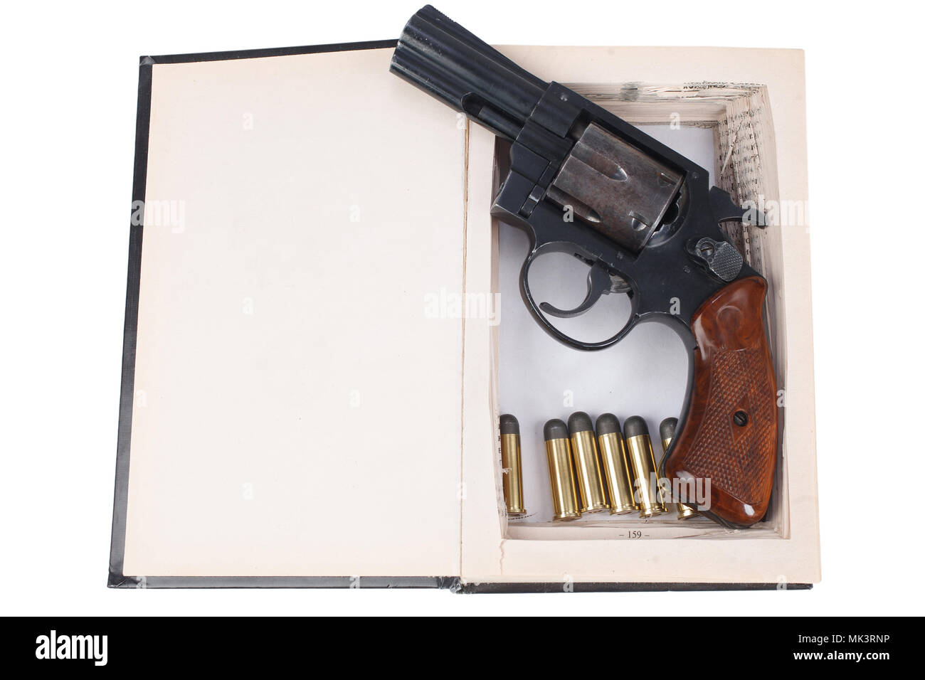 Revolver gun with cartridges hidden in a book isolated on white ...